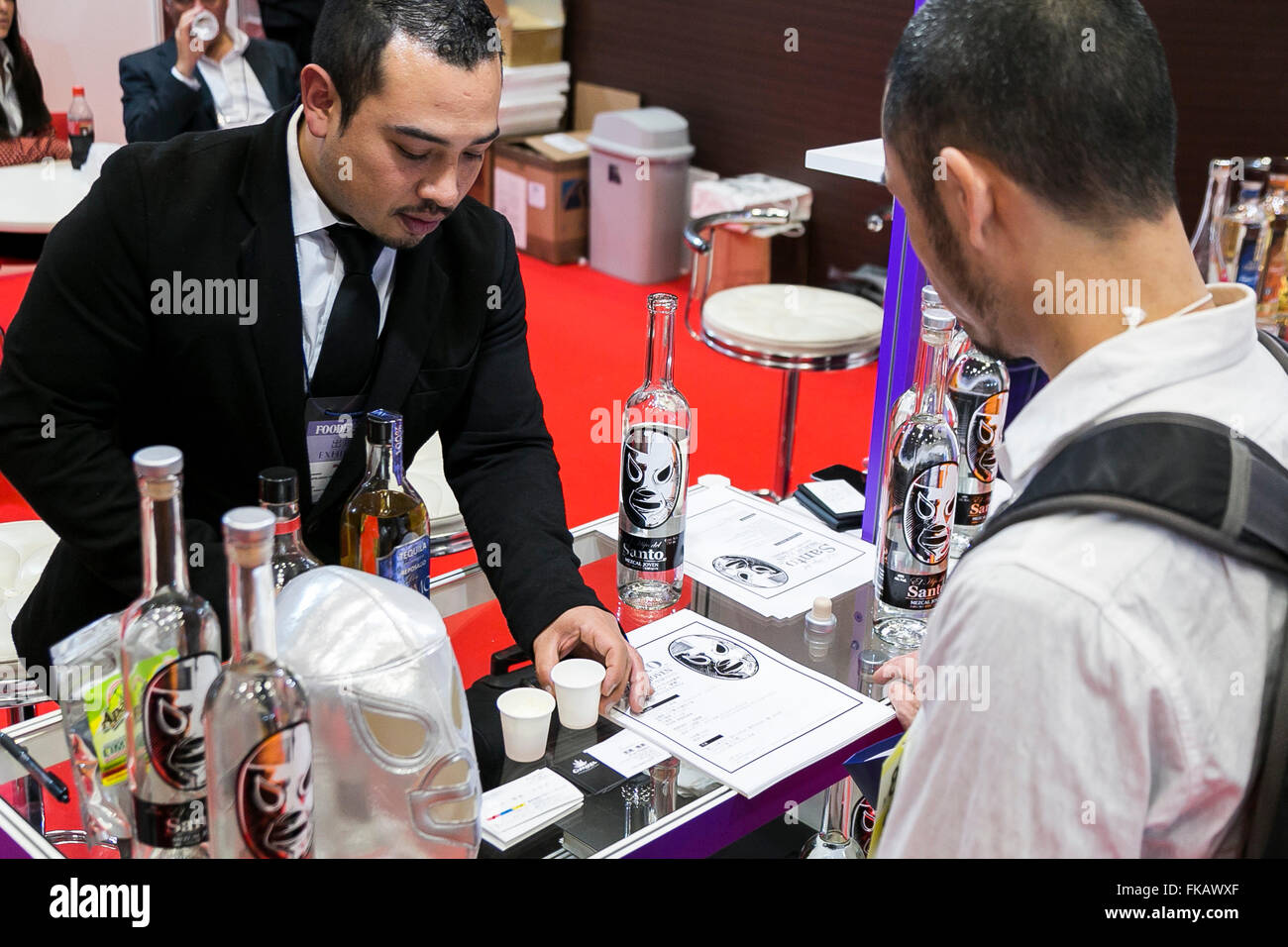 An exhibitor offers samples of his products to visitors at the Mexico ...
