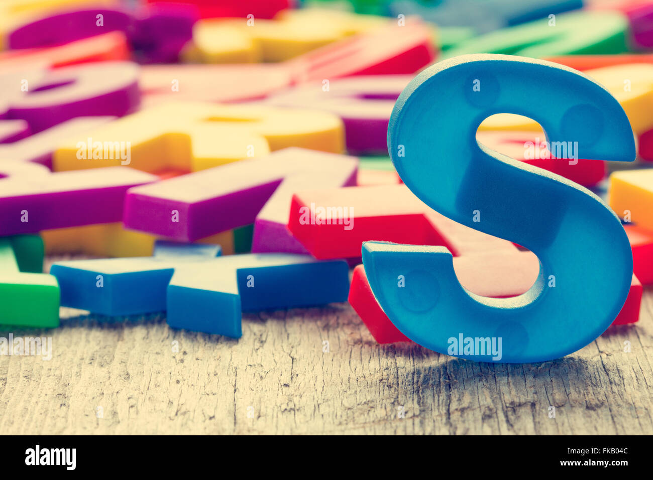 Capital letter S in a front of other colorful plastic letters. Vintage ...