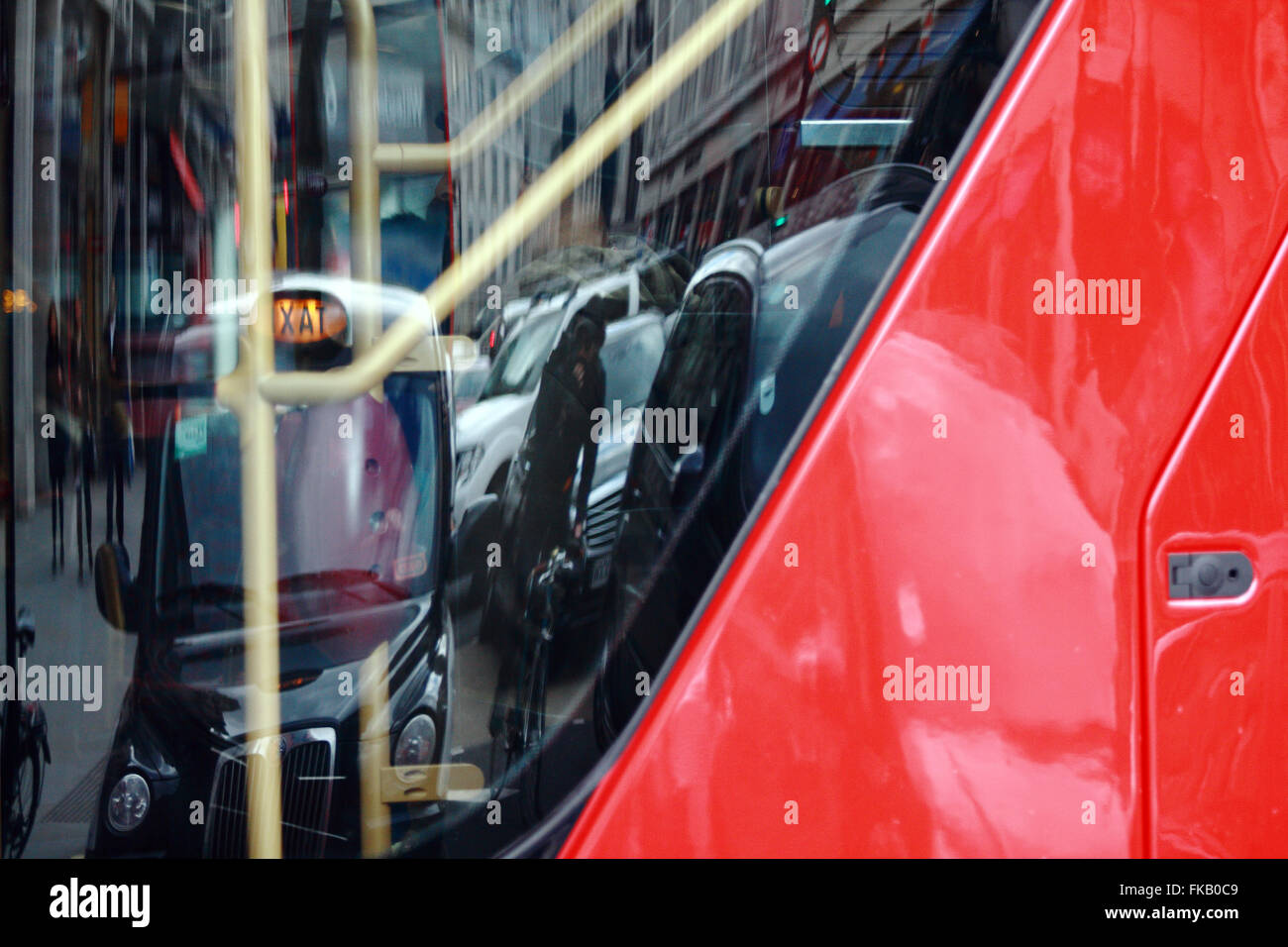 A black cab and other traffic reflected in the rear window of a double ...