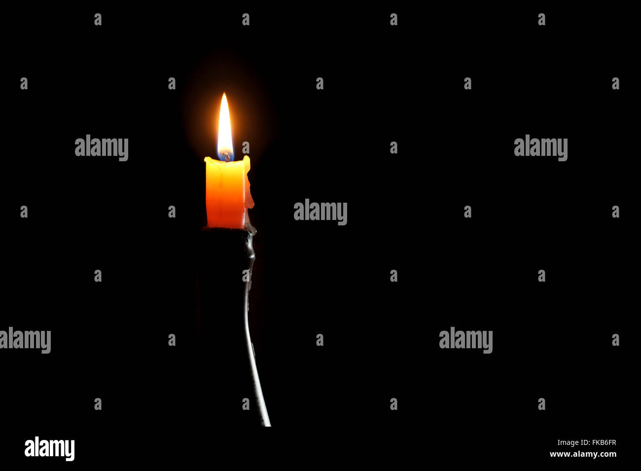 Single wax candle flame burning in darkness Stock Photo - Alamy