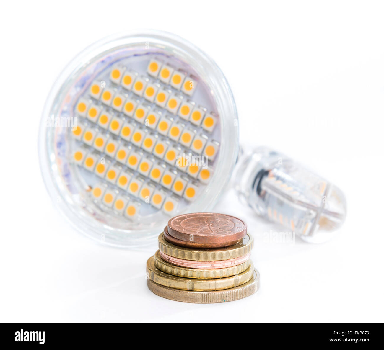 LED light bulb with european money (close-up shot) on white background ...