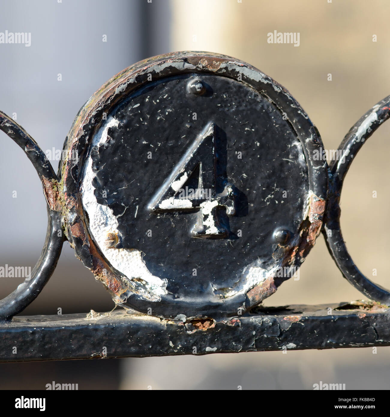 faded hand painted house number 4 sign on gate Stock Photo - Alamy