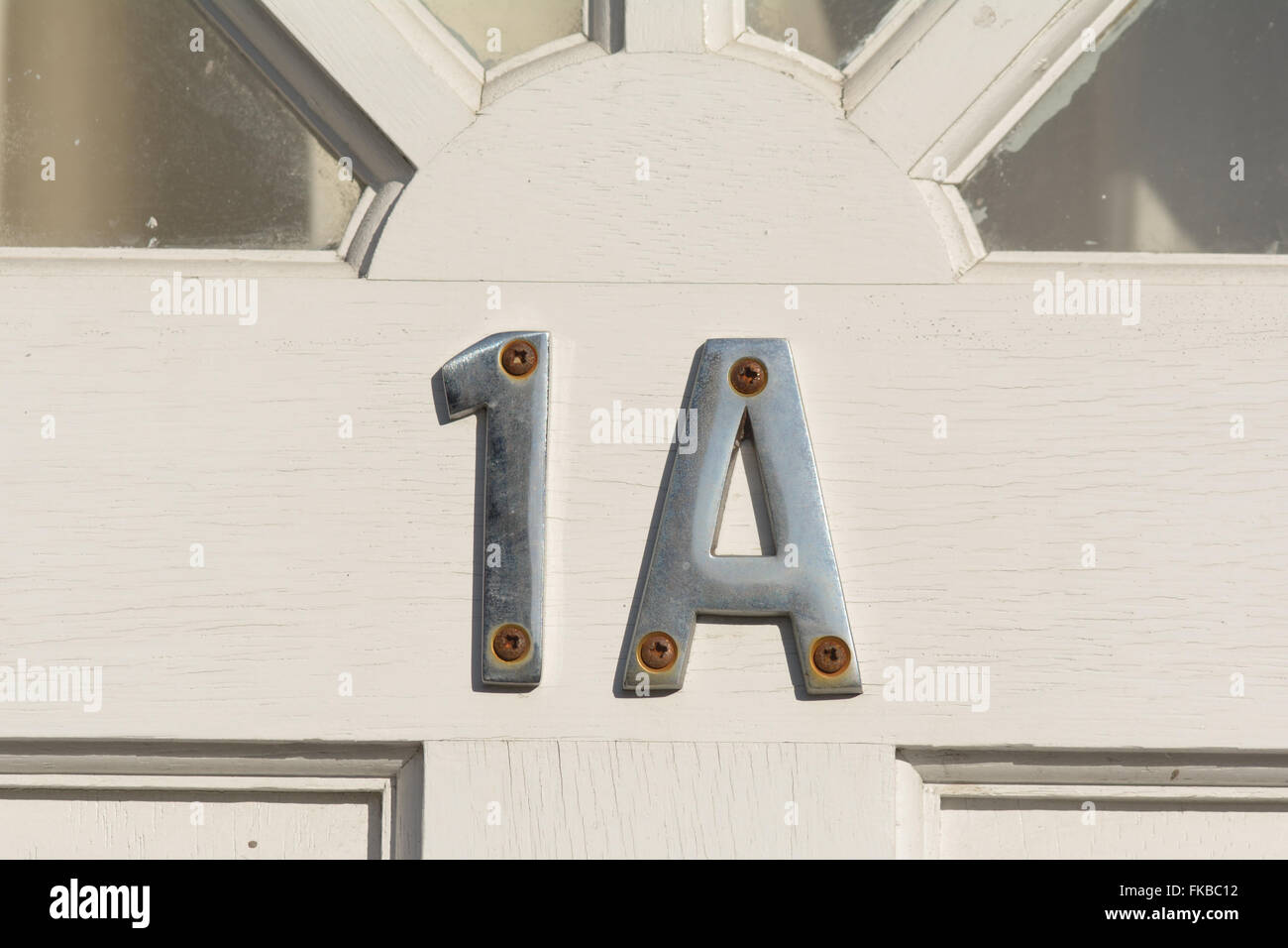 House number 1A sign on door Stock Photo - Alamy