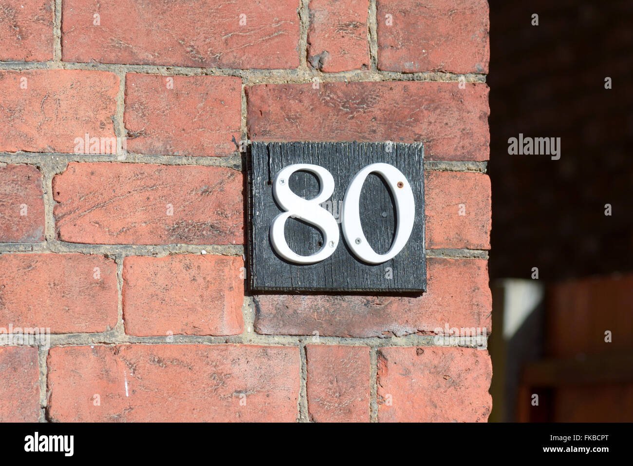 House number 80 sign on brick wall Stock Photo - Alamy