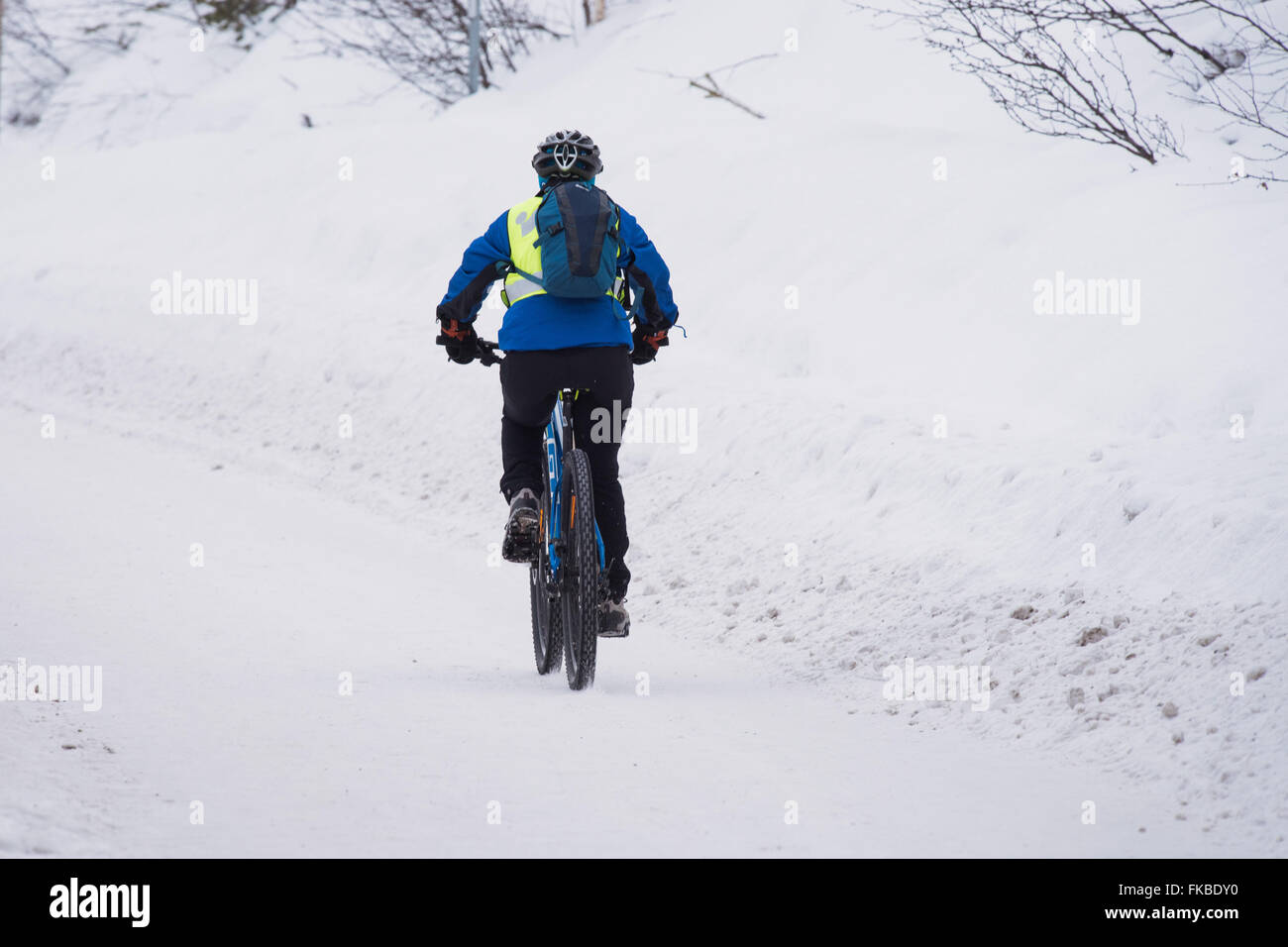 A man cycles up a snow-covered hill in Alta, Norway Stock Photo - Alamy