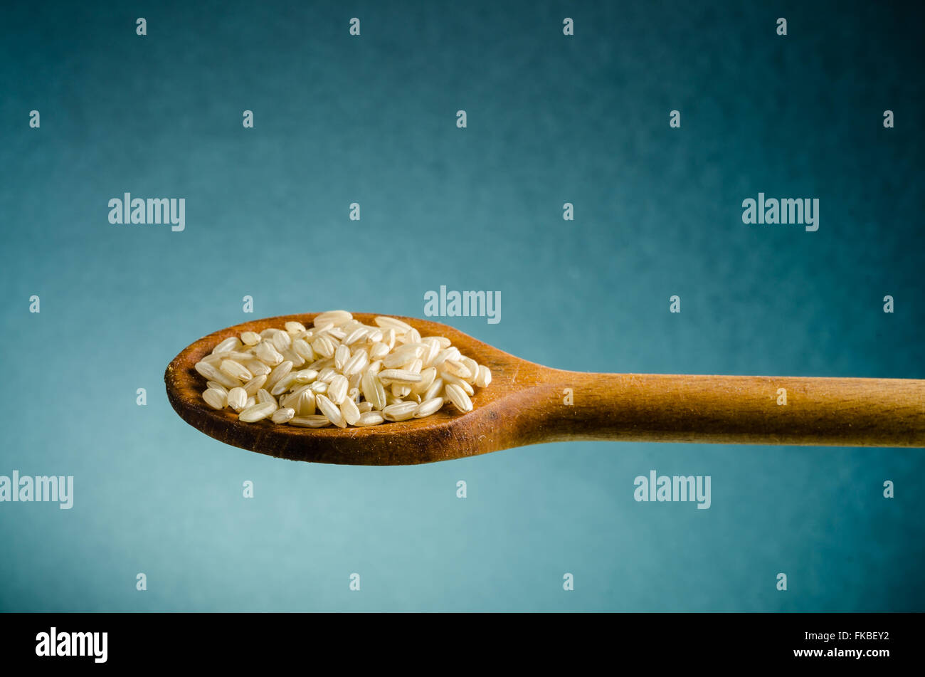 rice in a spoon, close up, color background Stock Photo - Alamy