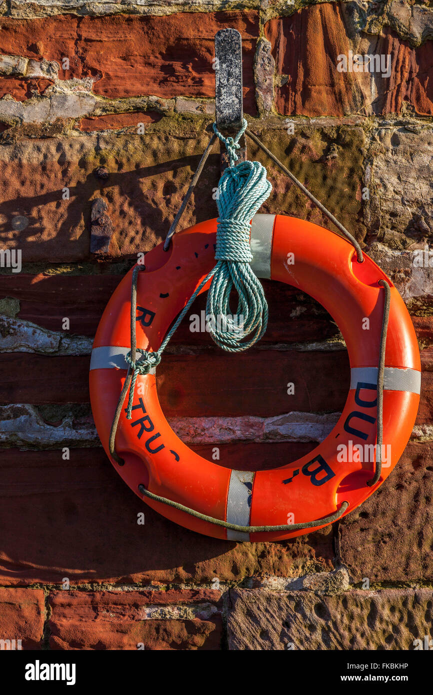 life ring on a harbour wall Stock Photo - Alamy