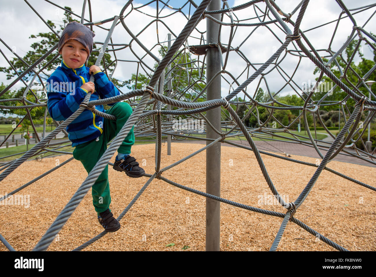 Boy climbing fence hi-res stock photography and images - Alamy