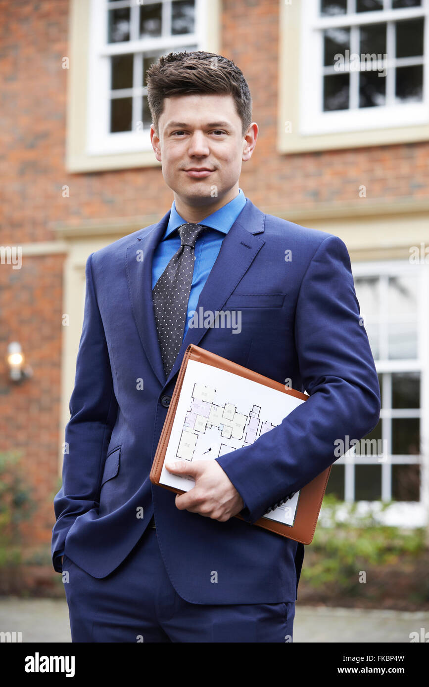 Portrait Of Realtor Standing Outside Residential Property Stock Photo ...