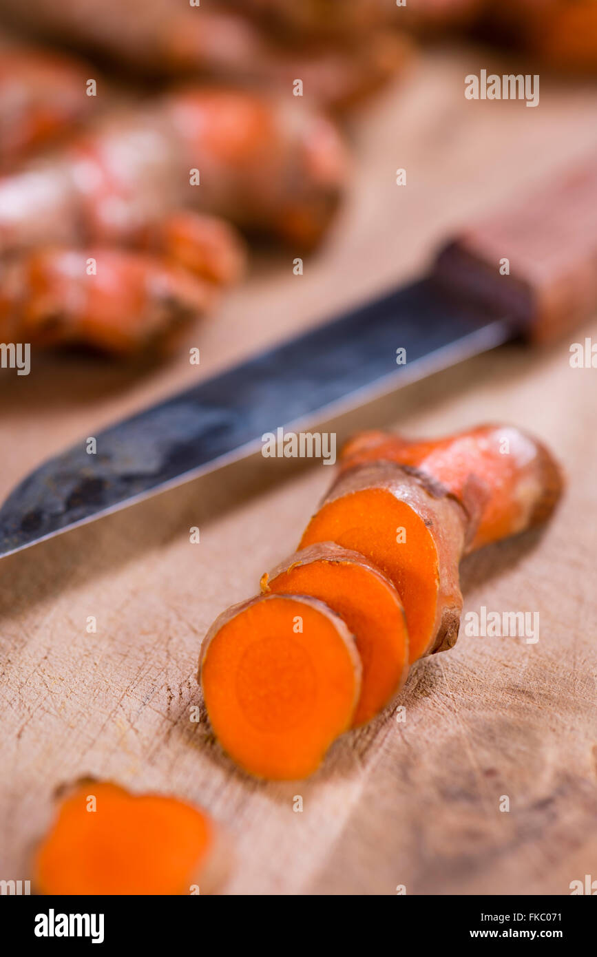 Some fresh Turmeric on an old wooden table (detailed close-up shot ...
