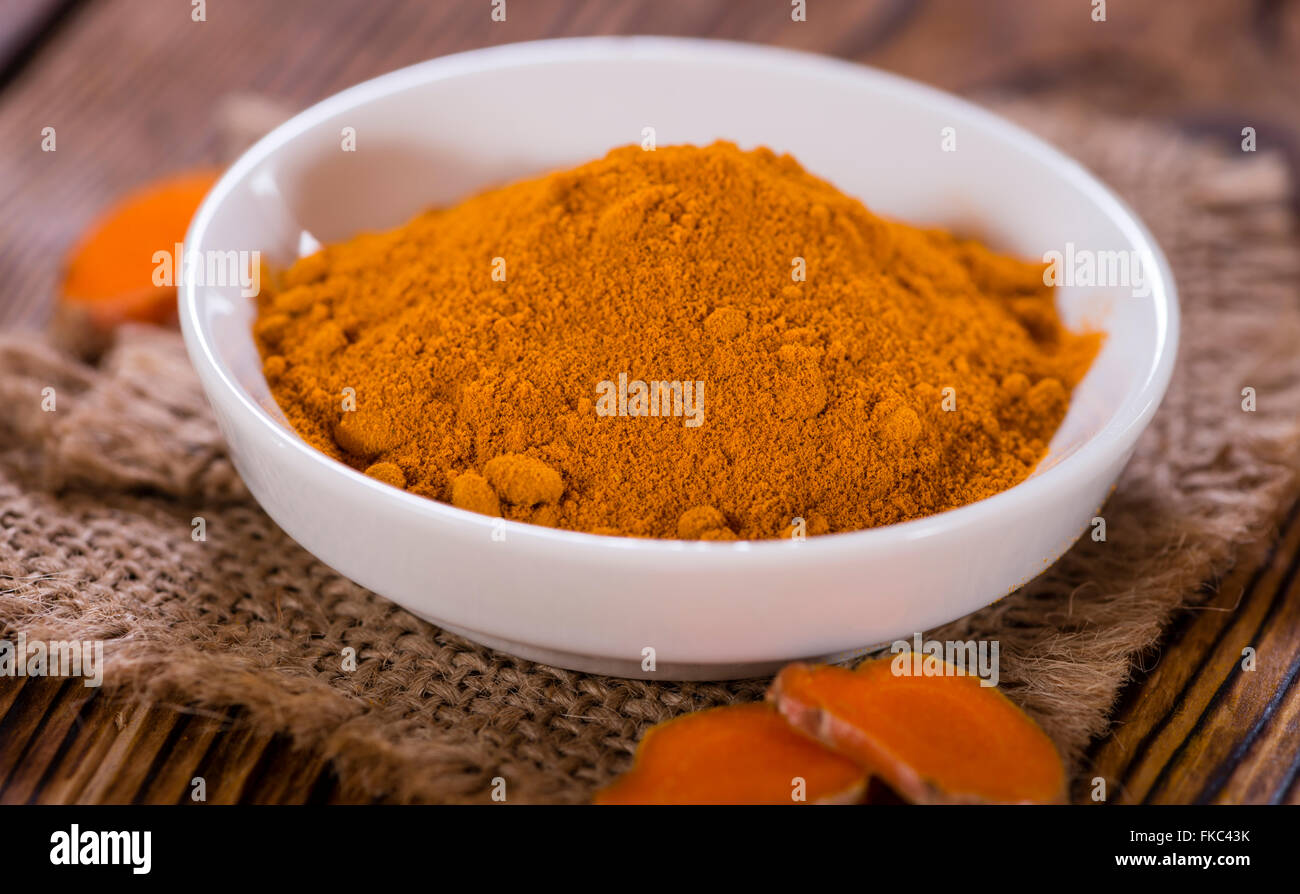 Heap of Turmeric (selective focus) on an old wooden table Stock Photo ...
