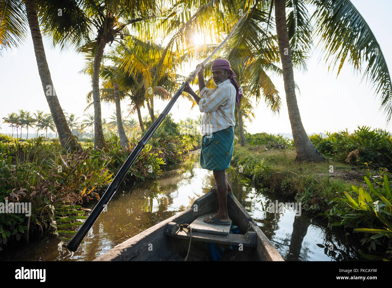 Anthony the boatman guiding the vessel through Keralan backwaters near ...