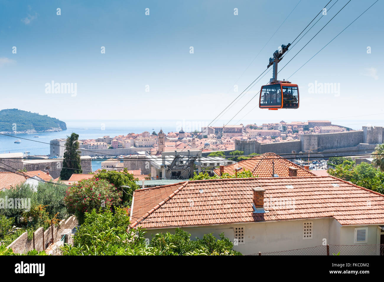 A cable car takes tourists across the old medieval town of Dubrovnik ...