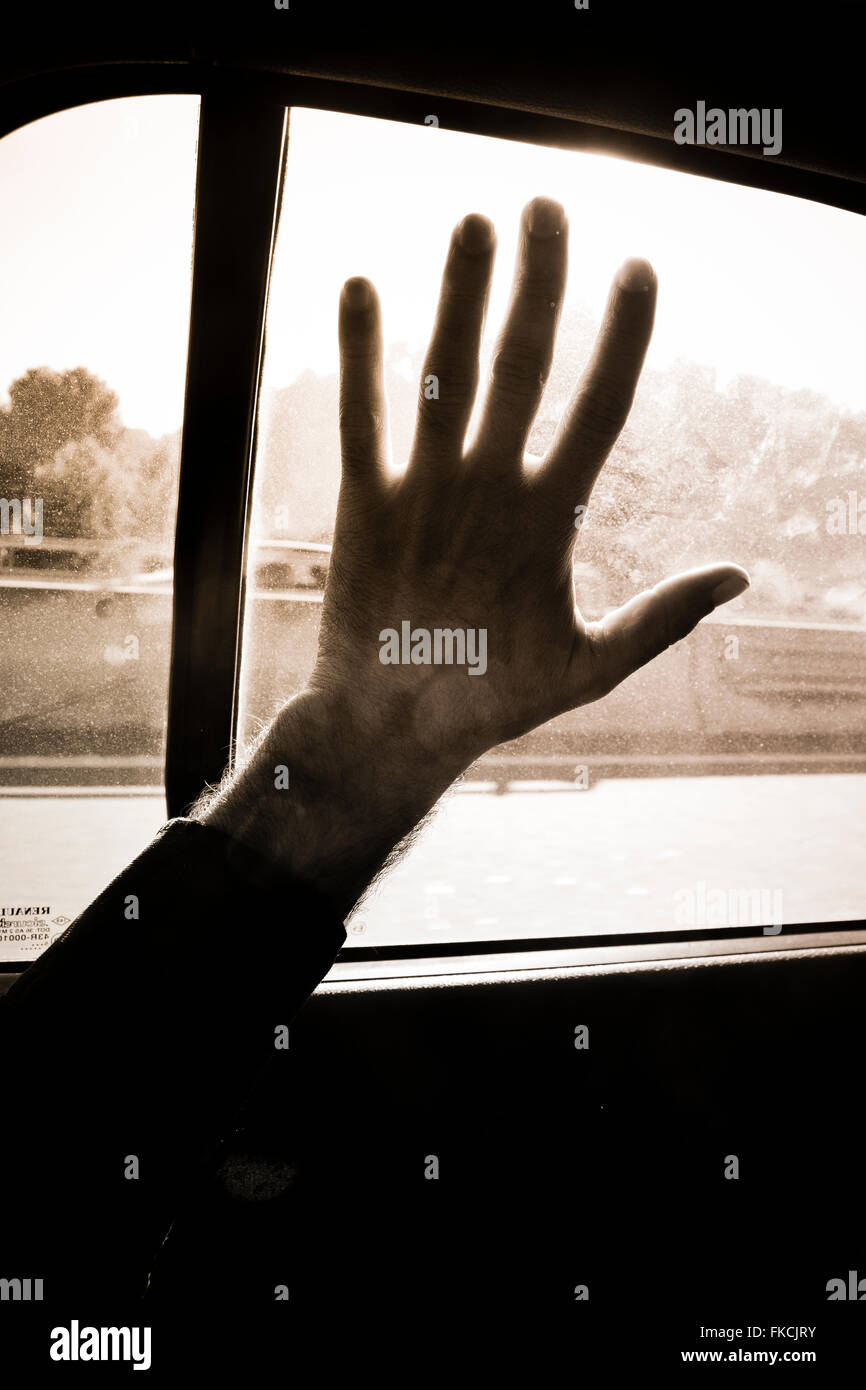 A hand on the glass of a window Stock Photo - Alamy