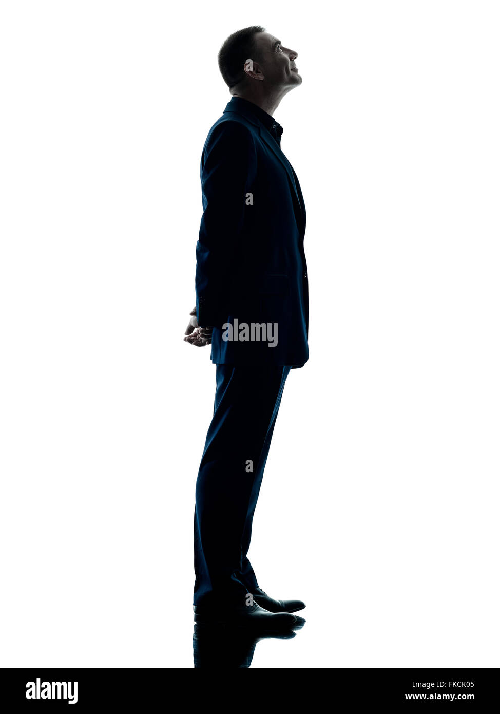 one caucasian business man standing profile silhouette isolated on white background Stock Photo ...
