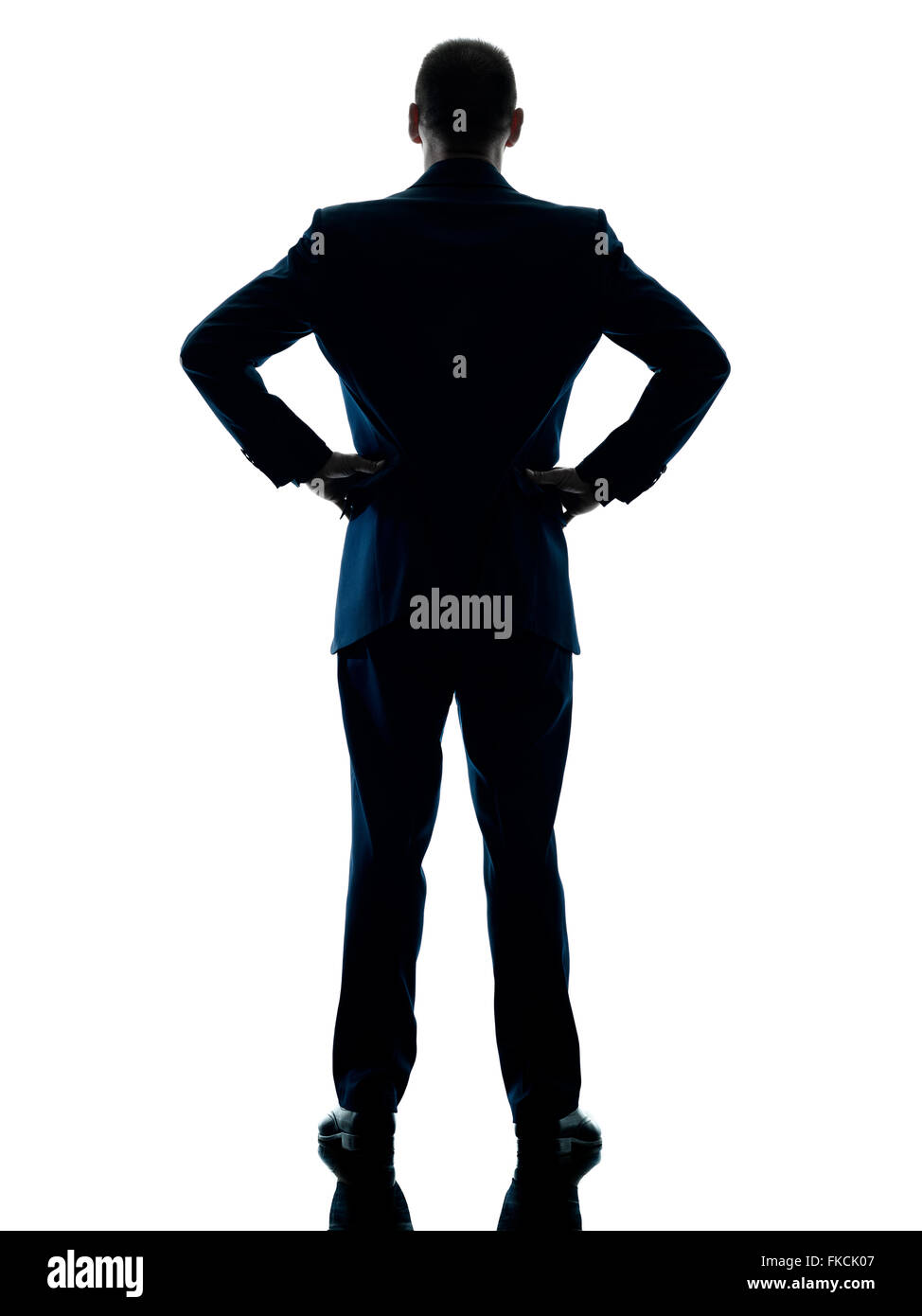 one caucasian business man standing rear view silhouette isolated on ...