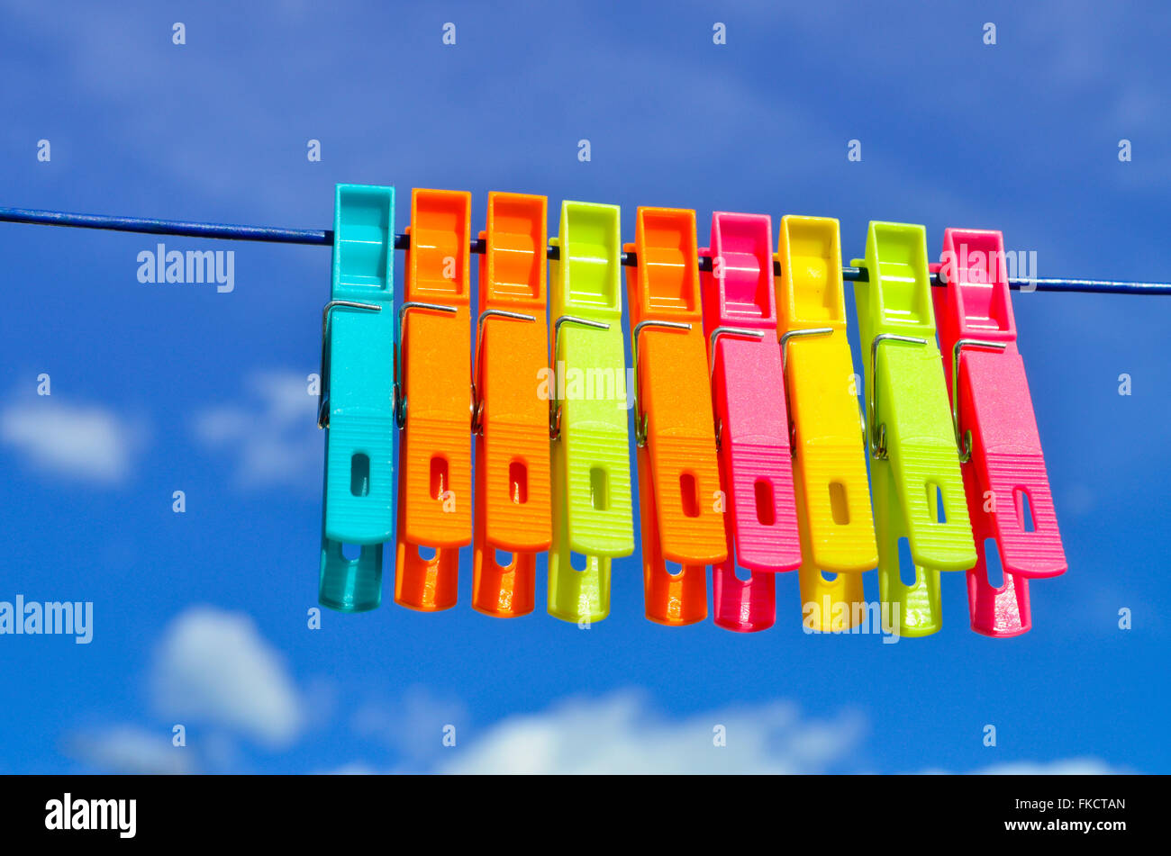 Plastic clothes pegs on washing line Stock Photo - Alamy