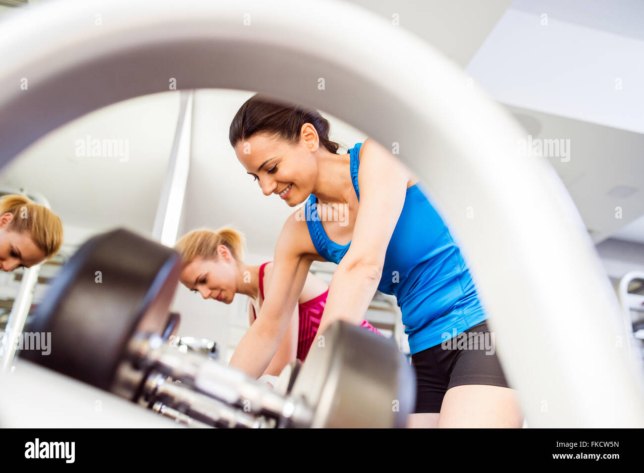 Detail of women in gym working out with weights Stock Photo - Alamy
