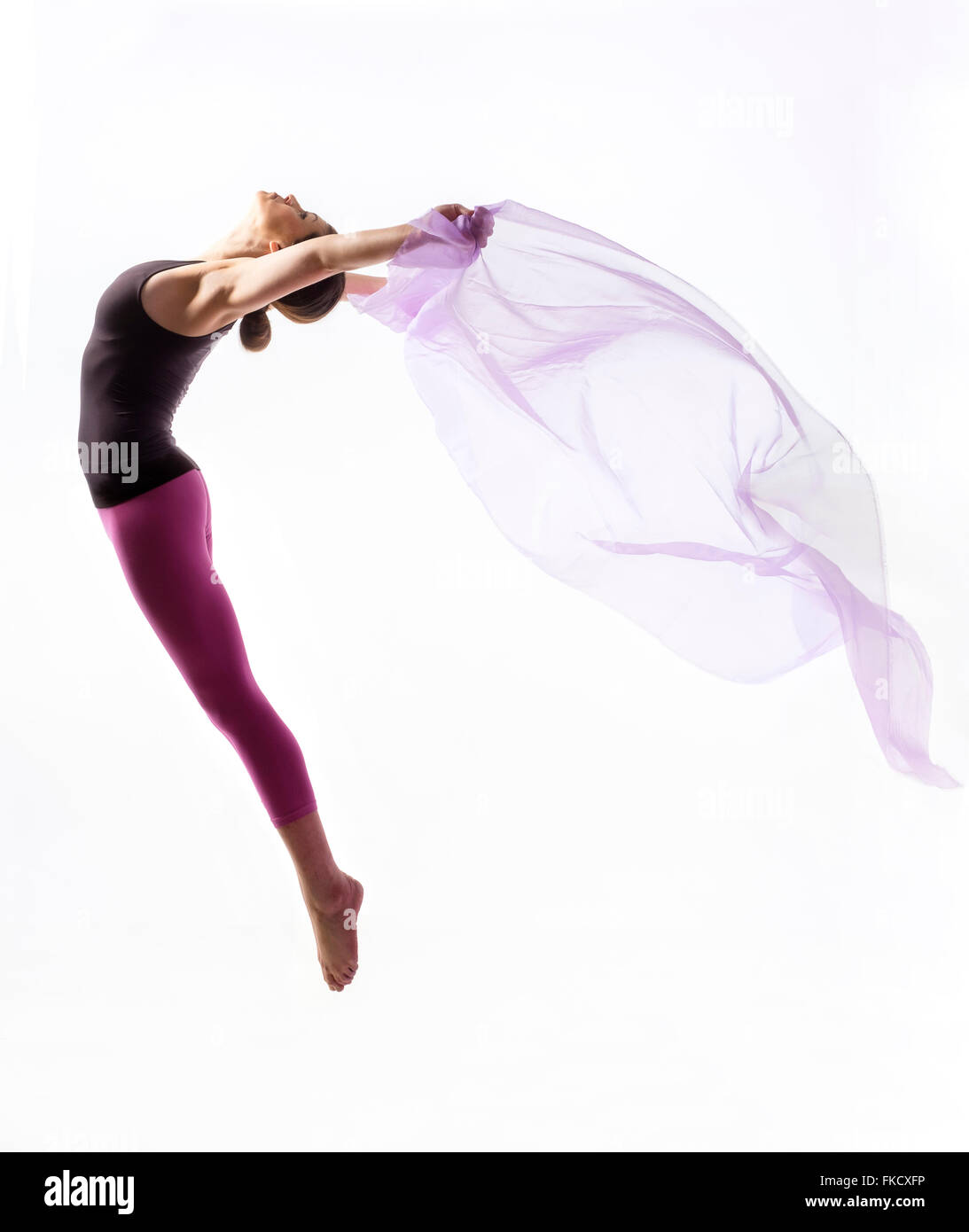 Woman with sheer fabric jumping Stock Photo - Alamy