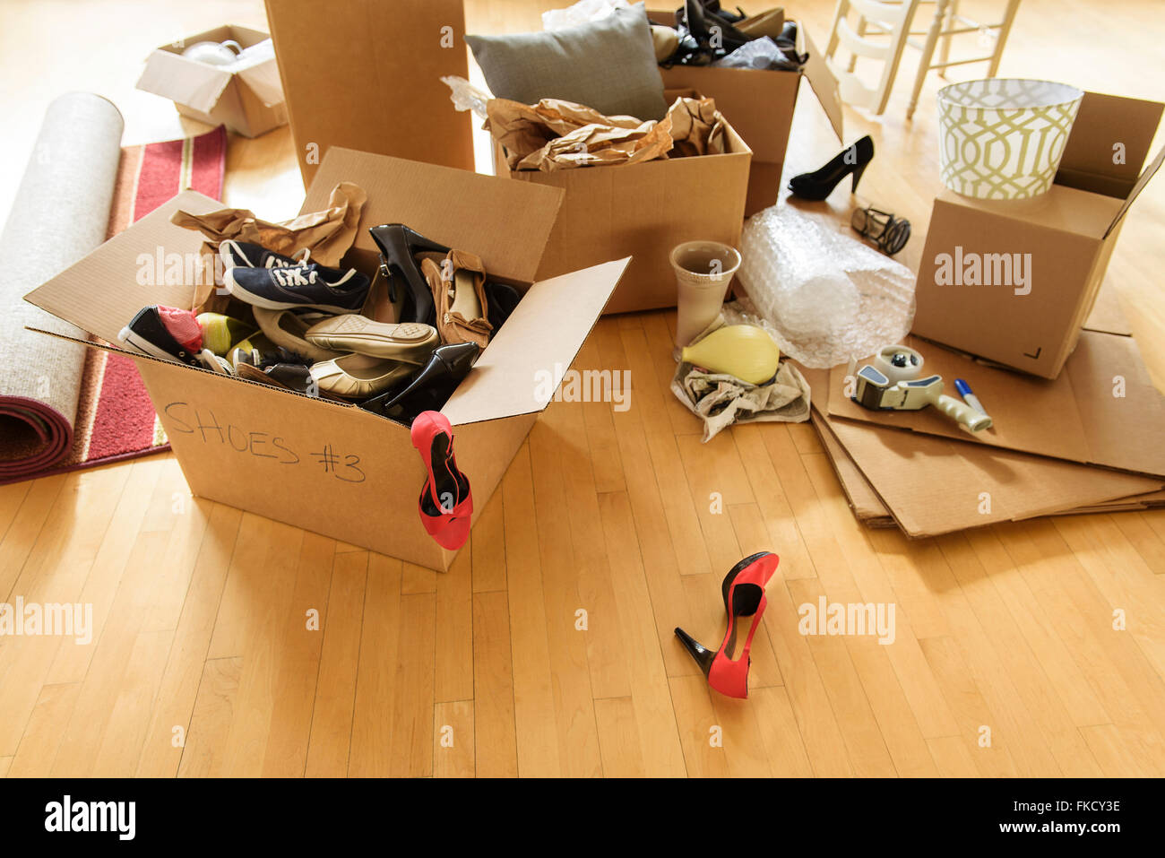 Cardboard boxes on wooden floor Stock Photo - Alamy