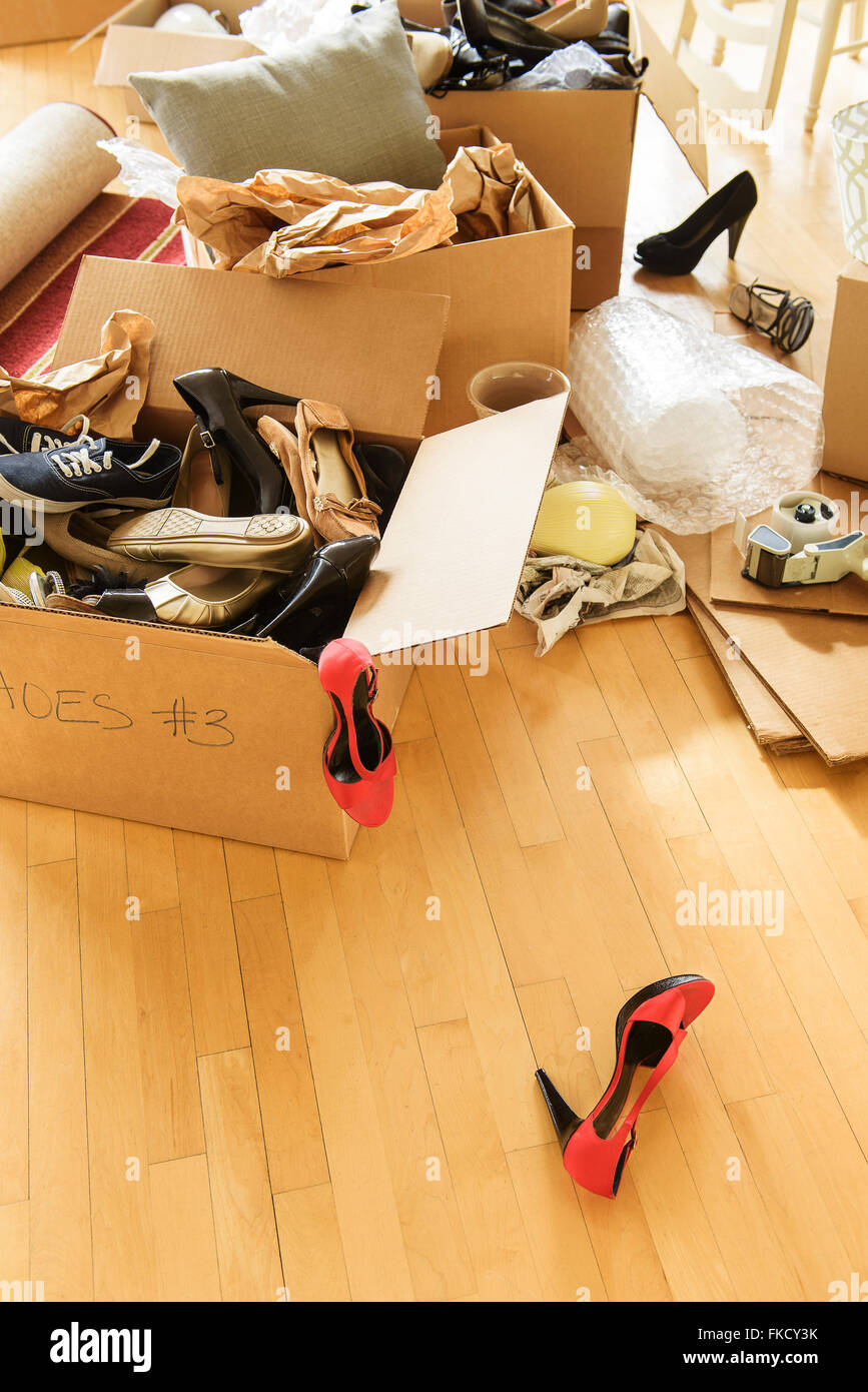 Cardboard boxes on wooden floor Stock Photo - Alamy