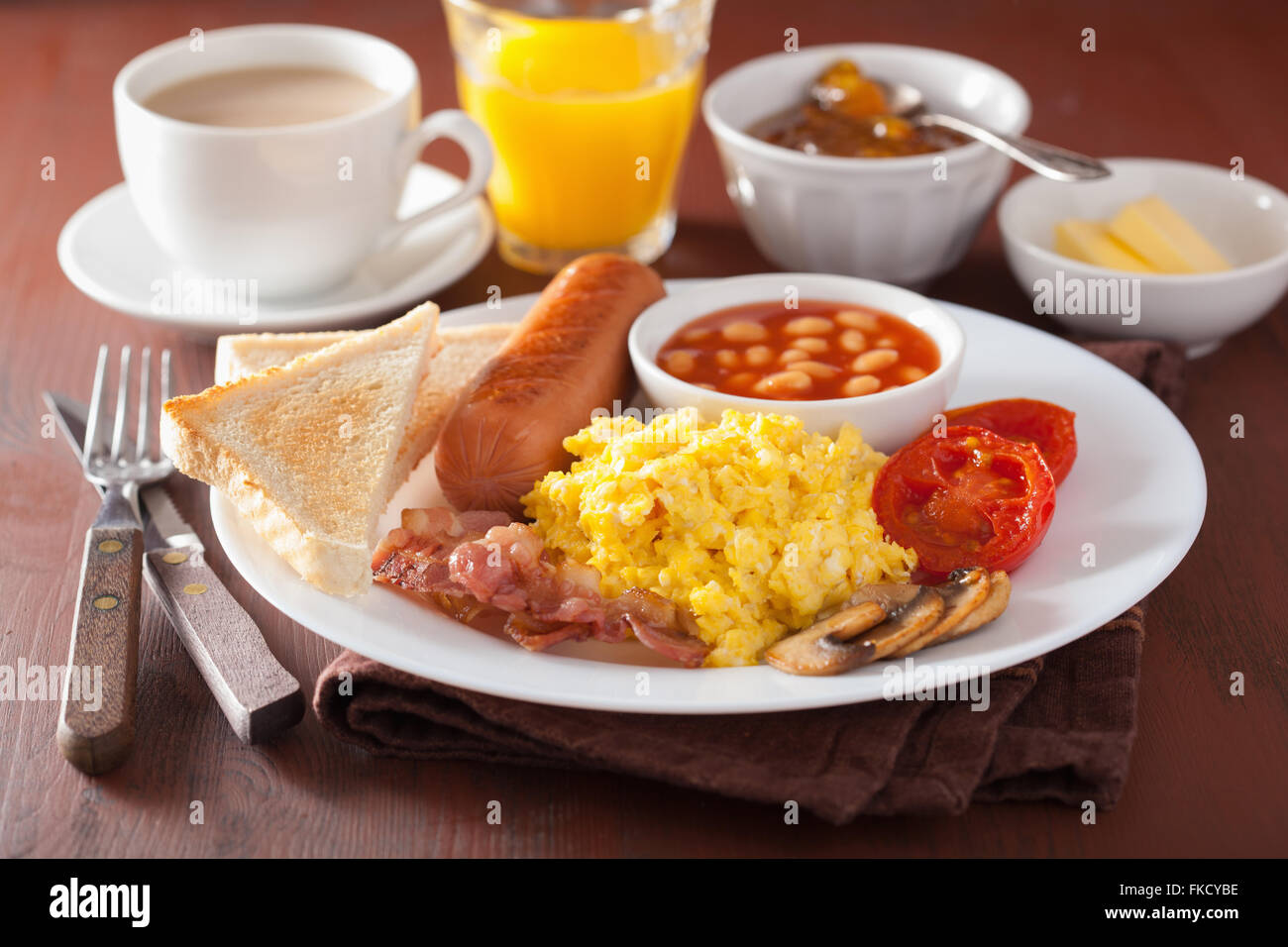 full english breakfast with scrambled eggs, bacon, sausage, beans ...