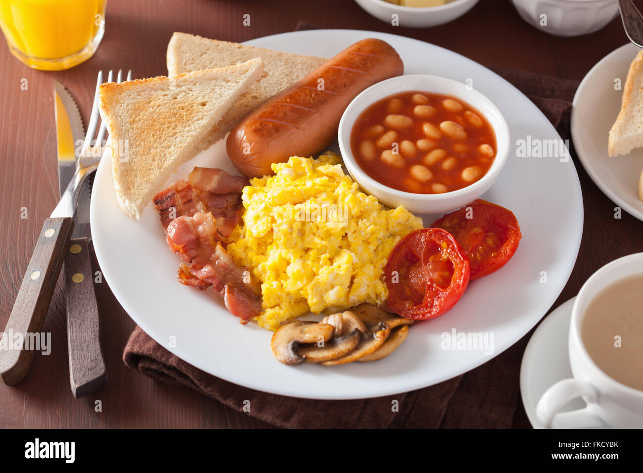 full english breakfast with scrambled eggs, bacon, sausage, beans ...