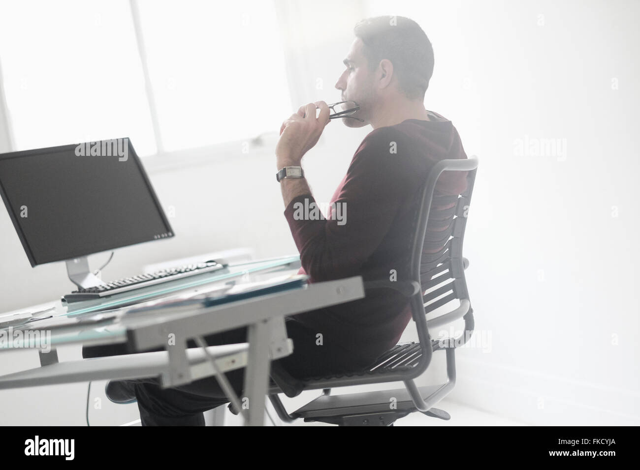 Man sitting at desk in office Stock Photo - Alamy