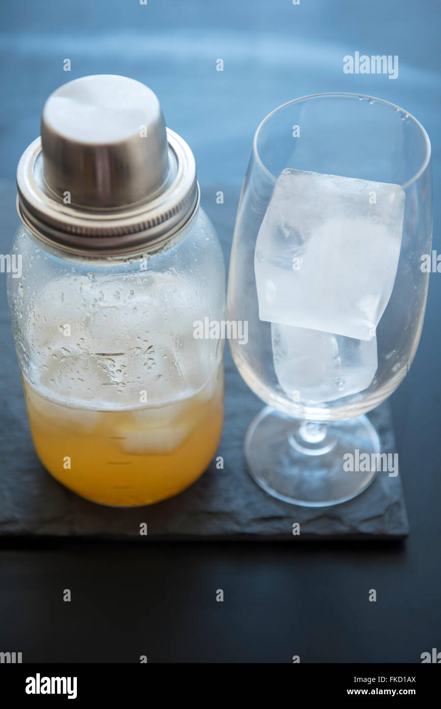 Ice cubes in drinking glass and cocktail shaker Stock Photo - Alamy