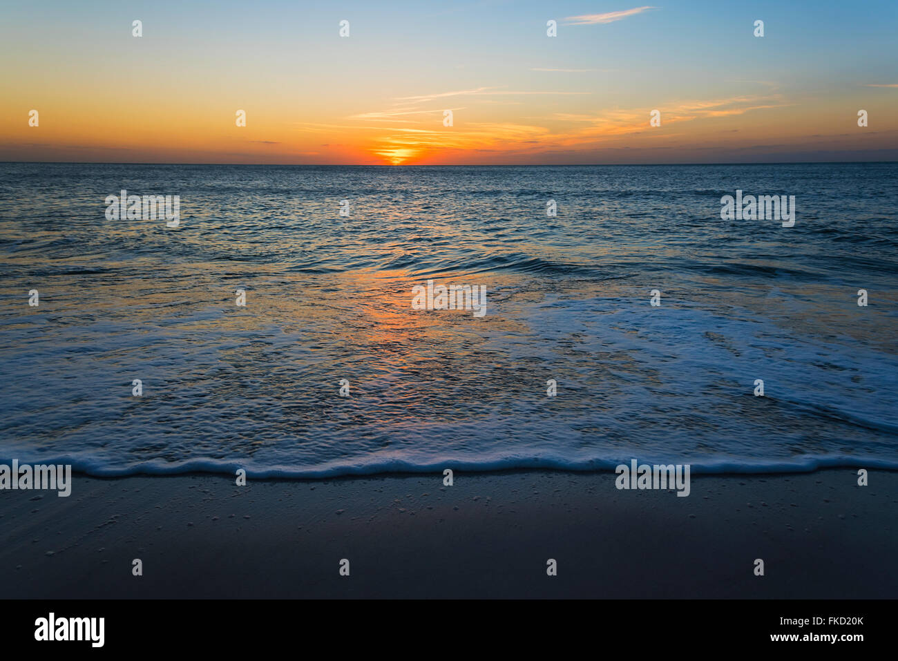 Beach and sea at sunset Stock Photo - Alamy
