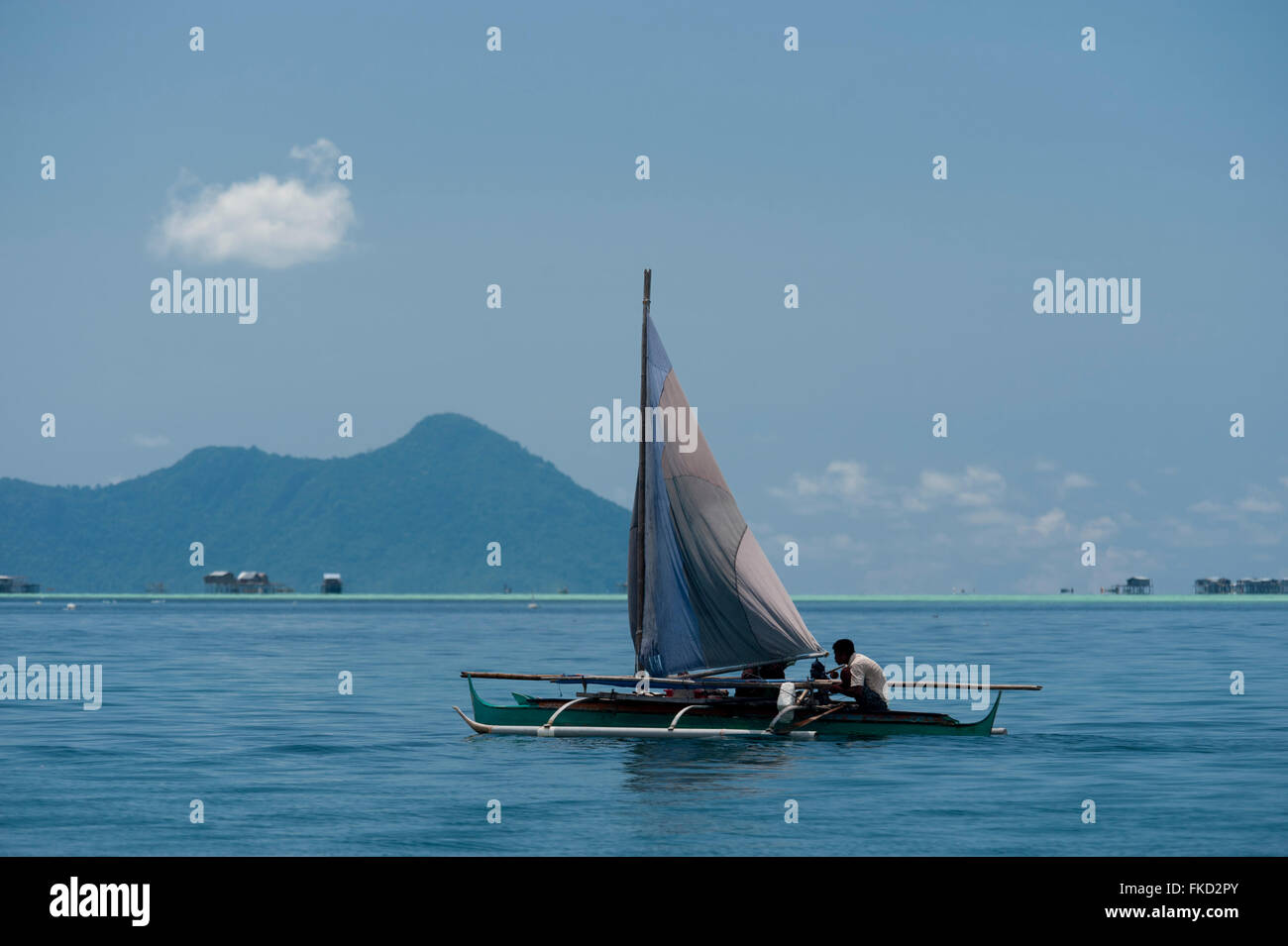 Outrigger boat wind powered by sail Stock Photo - Alamy