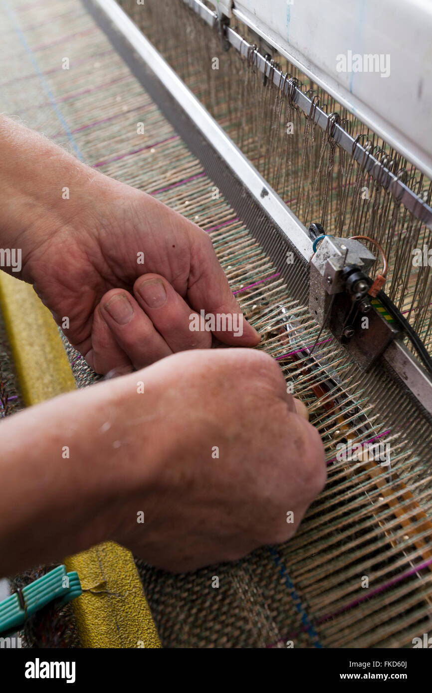 Neil Macleod, Harris tweed weaver, works his loom at home in Stornoway ...