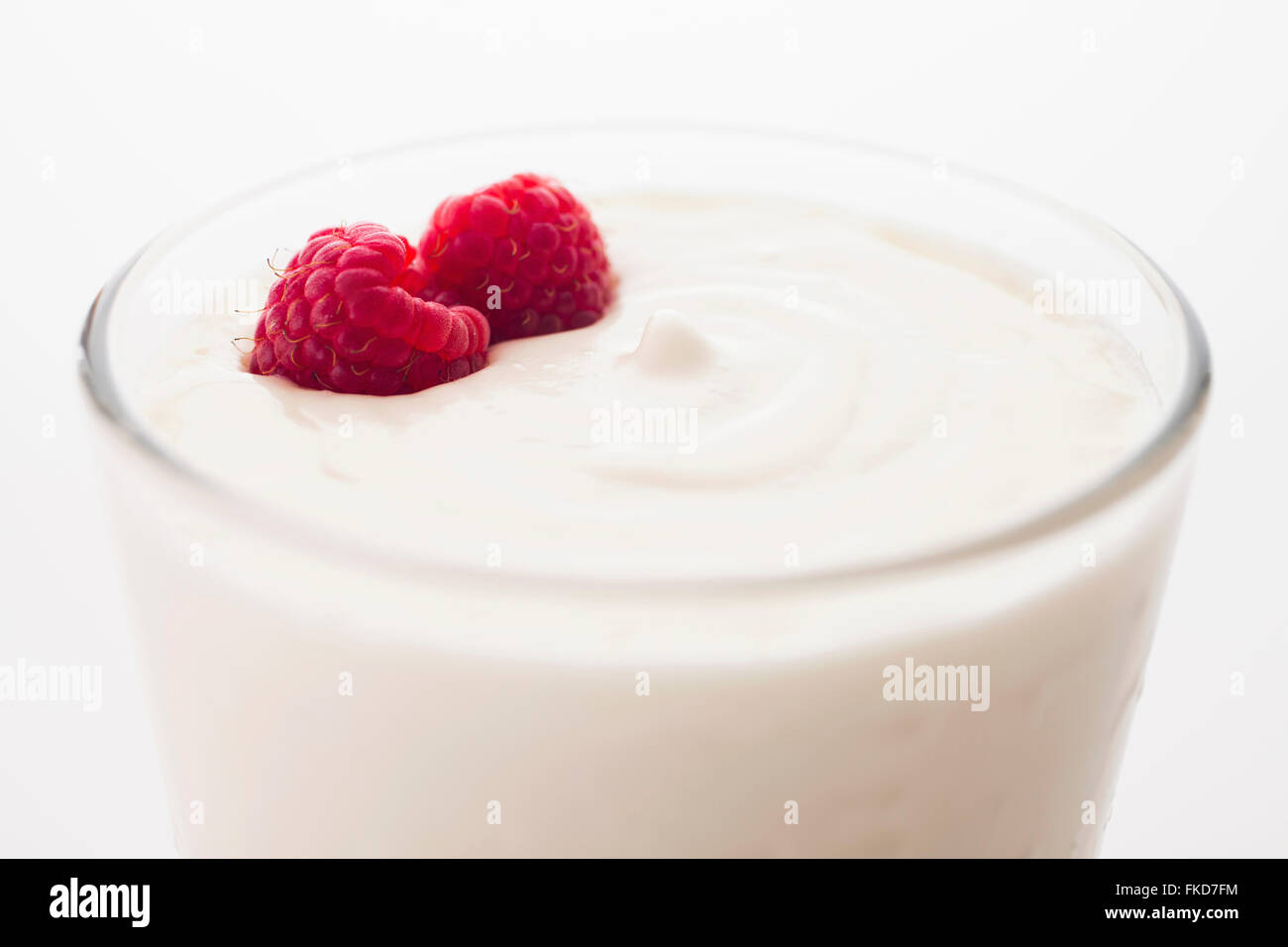 Yogurt with raspberries in drinking glass Stock Photo - Alamy