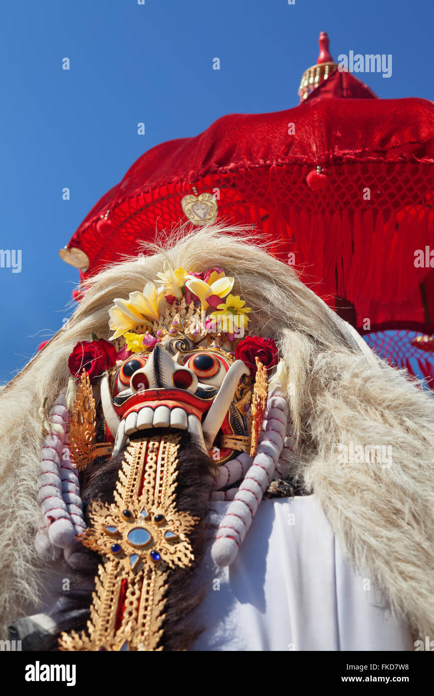 Rangda Mask under red umbrella in temple traditional spirit of Bali at ...