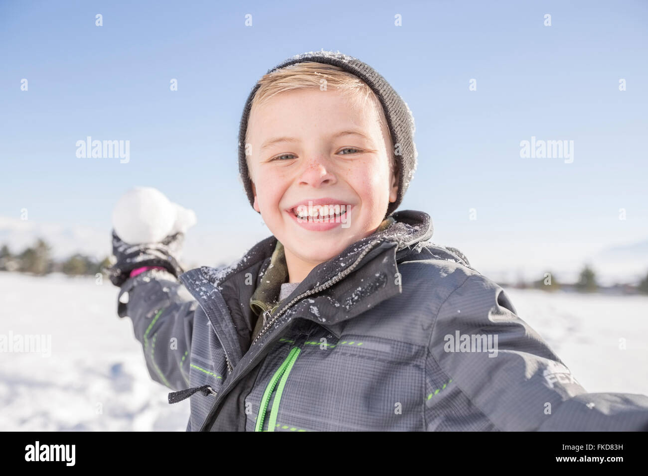 Portrait of boy (8-9) throwing snowball Stock Photo - Alamy