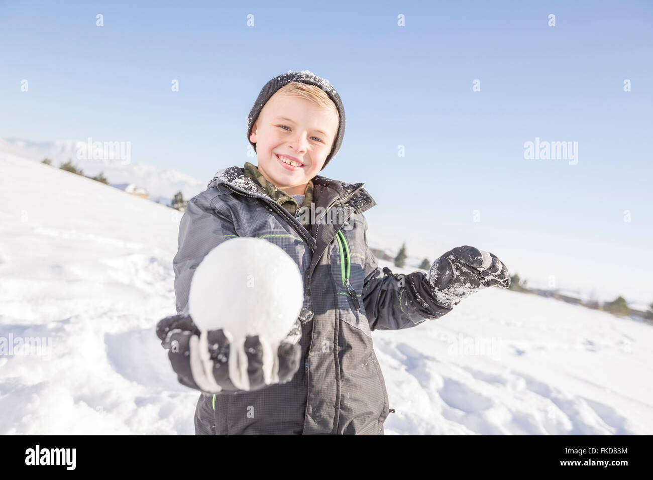 Portrait smiling boy holding snowball hi-res stock photography and ...