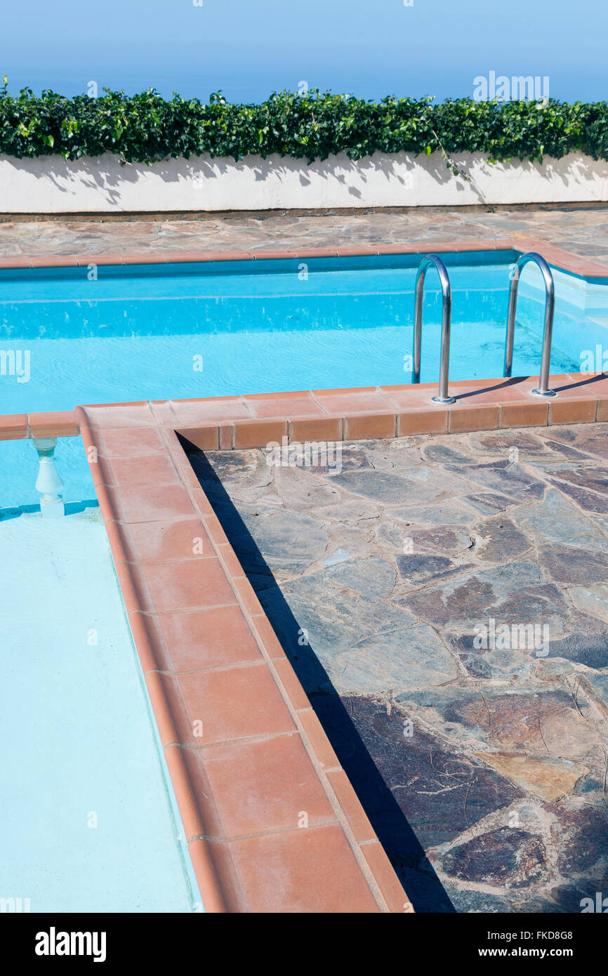 empty swimming pool with ivy on wall and blue sky Stock Photo - Alamy