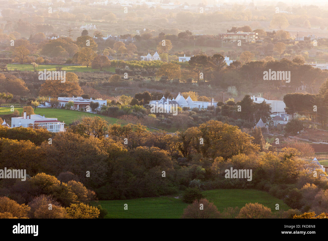 Landscape with trulli houses at sunset Stock Photo - Alamy
