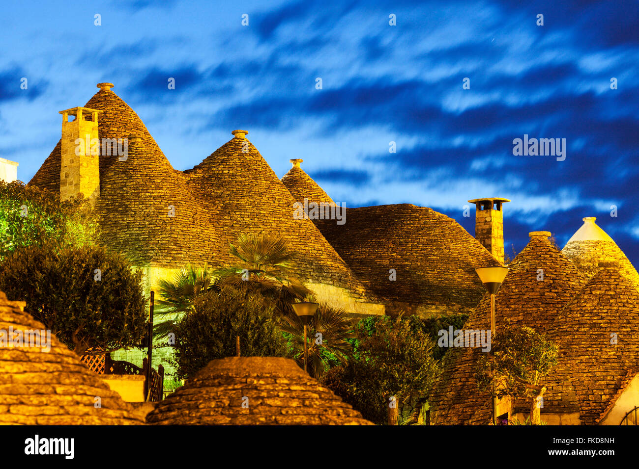 Traditional roofs of trulli houses at sunset Stock Photo - Alamy