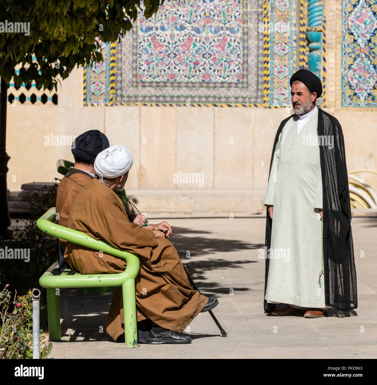Three mullahs engaged in conversation, courtyard of Khan Madrassah ...