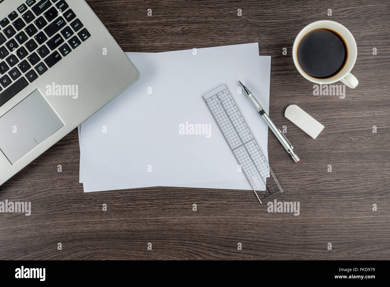 Laptop, paper pen Ruler and Eraser with cup of coffee on work desk ...