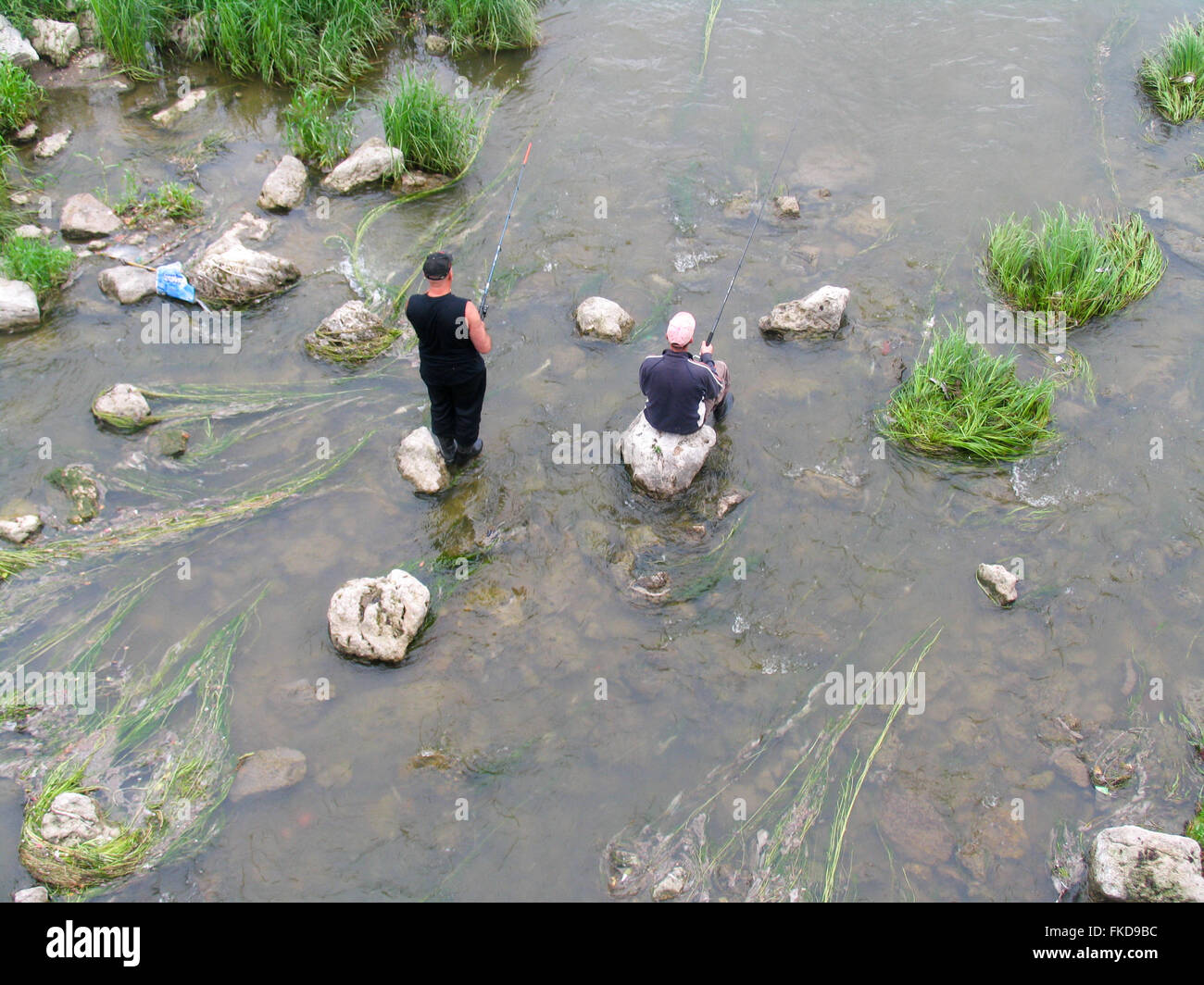 Two men on river rocks two men on river rocks hi-res stock photography ...