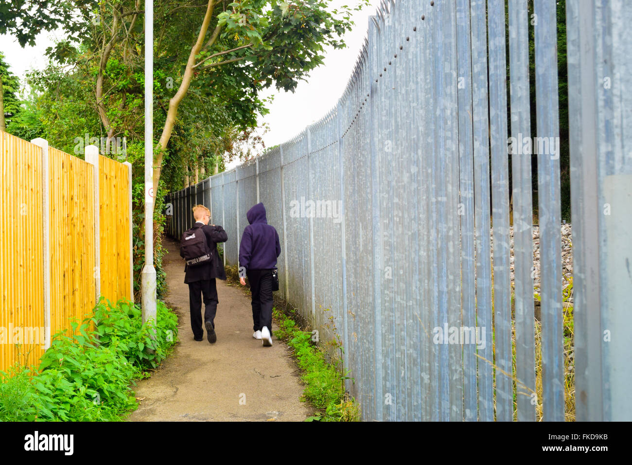 Two boys walking between two walls. London, England, United Kingdom ...