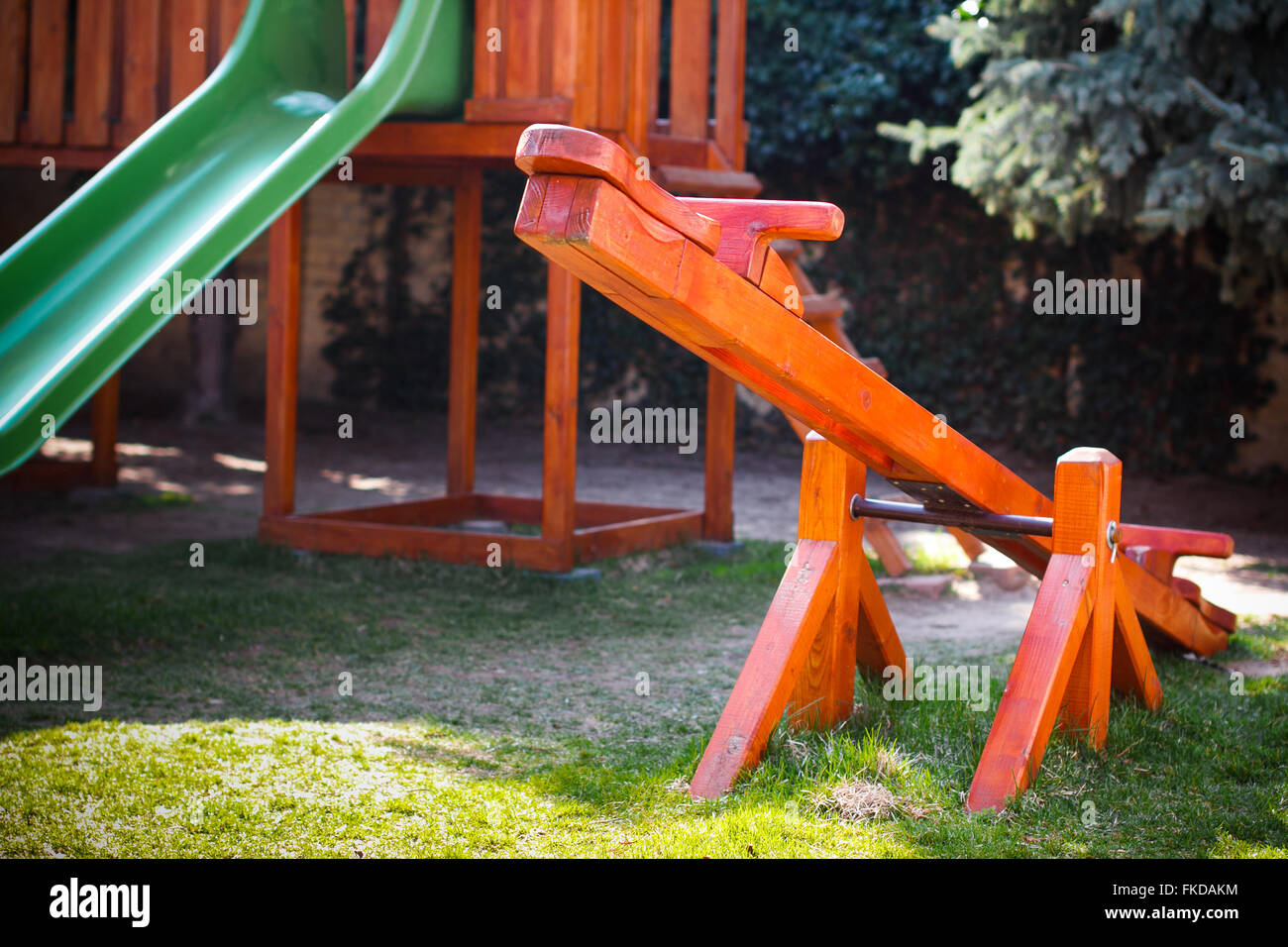 Old wood seesaw with slider system, kindergarten Stock Photo - Alamy