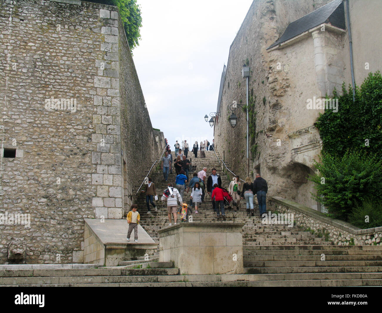 People climbing and descending steep steps Stock Photo - Alamy