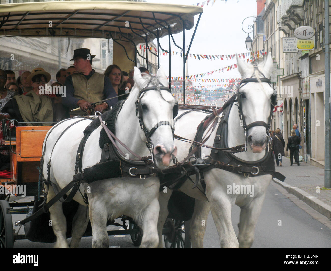 A horse drawn carriage with passengers Stock Photo - Alamy