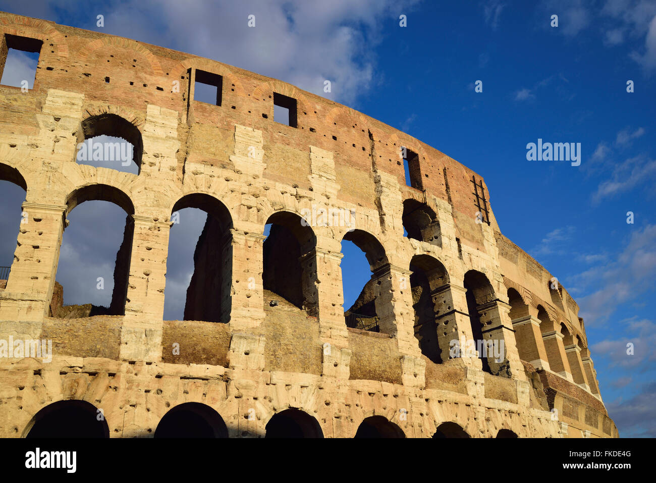 Facade of Coliseum against cloudy sky Stock Photo - Alamy