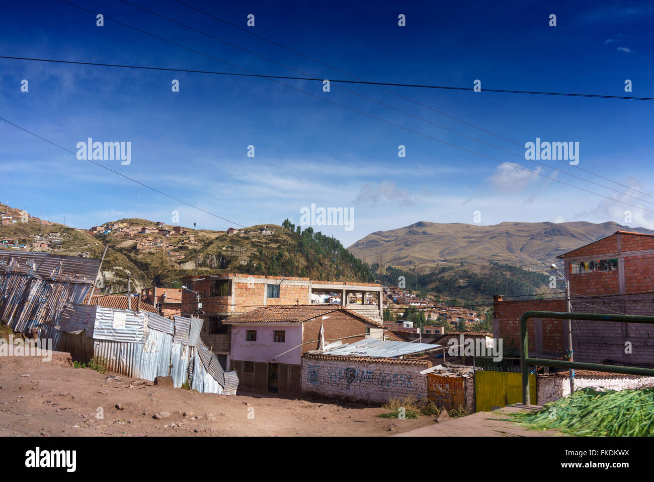 Village on hill against sky with mountain in background, Cusco, Peru ...