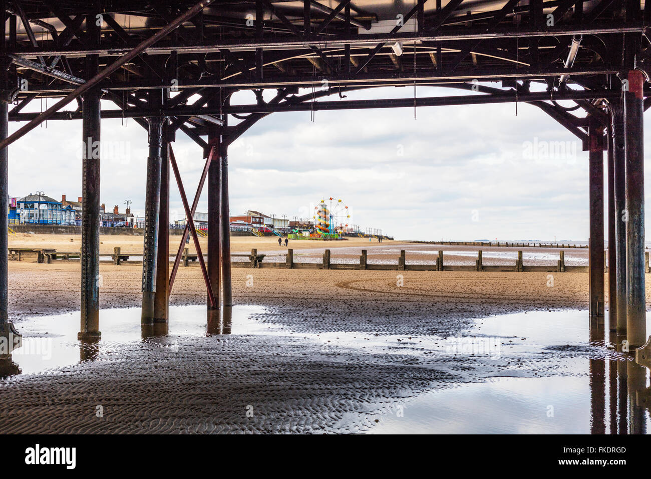 Cleethorpes UK beach coastline from under pier towards amusements ...