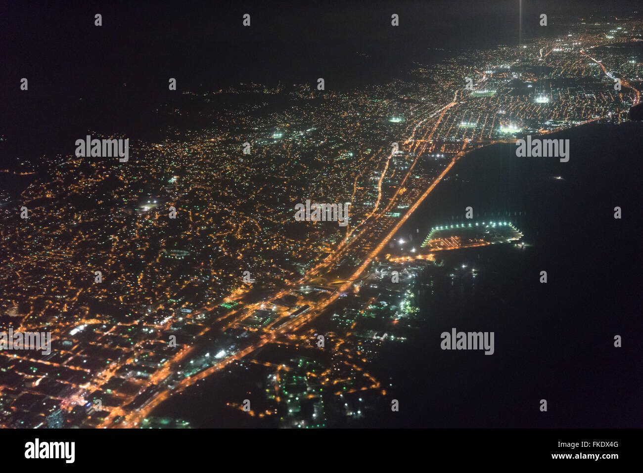 Aerial view of illuminated city seen through airplane at night ...